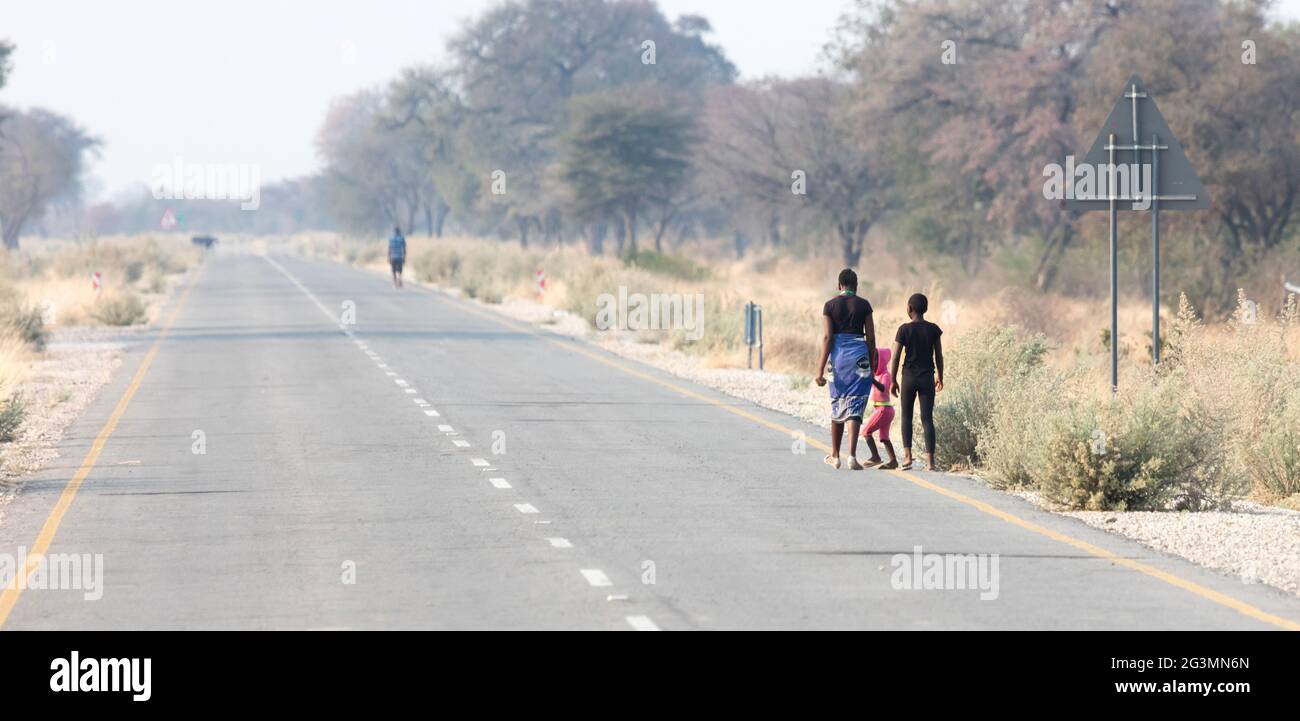 People walking at the side of the road Stock Photo - Alamy