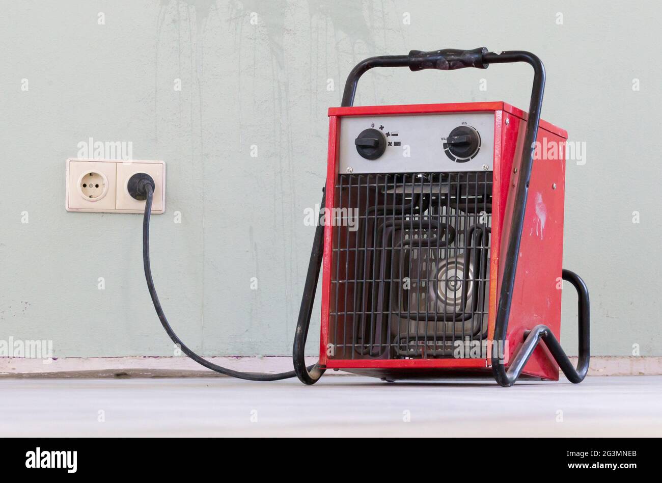 Compact red heater, drying the floor Stock Photo - Alamy
