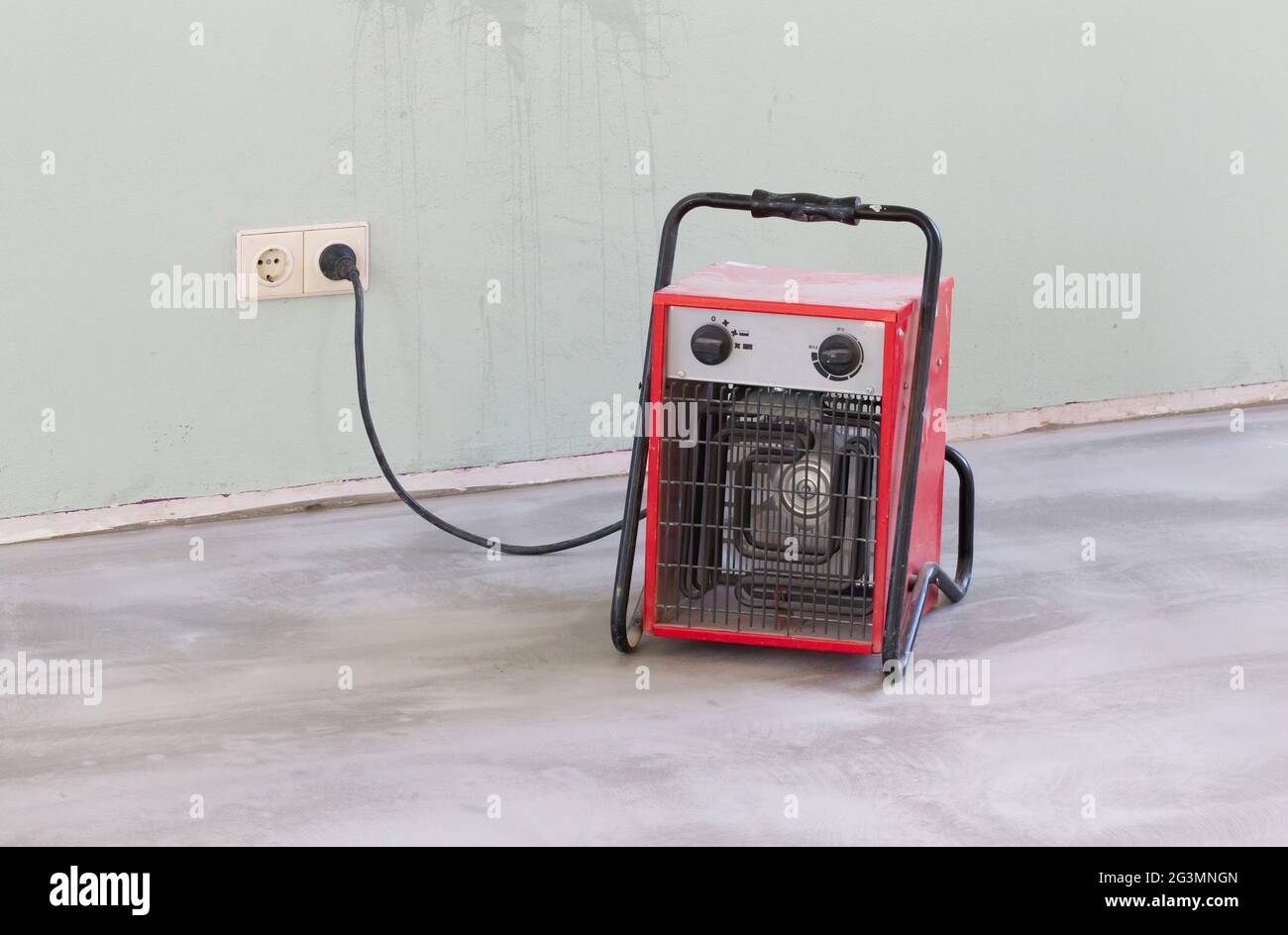 Compact red heater, drying the floor Stock Photo - Alamy