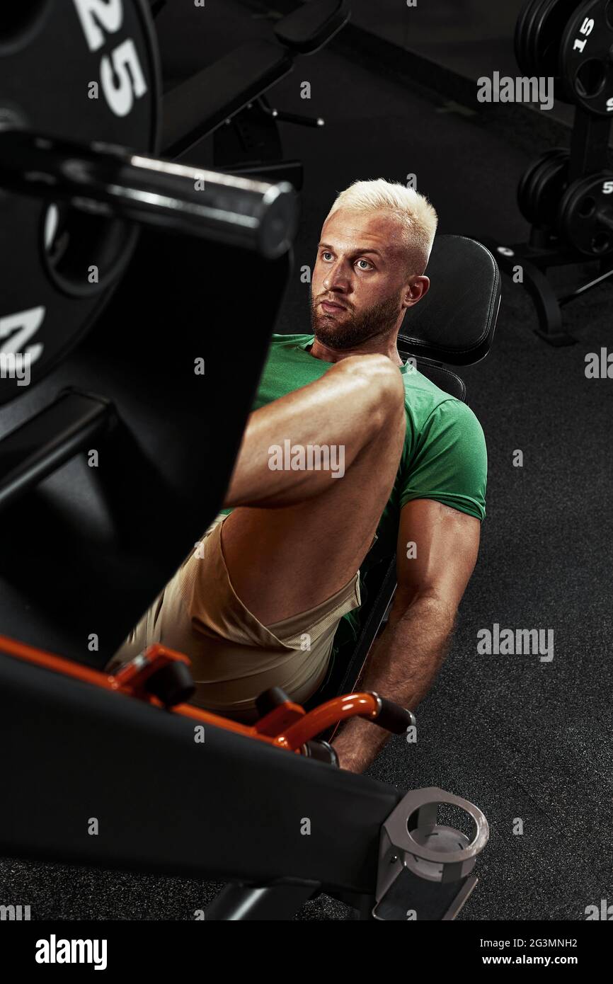 Training legs in the simulator, the athlete works with his legs on the ...