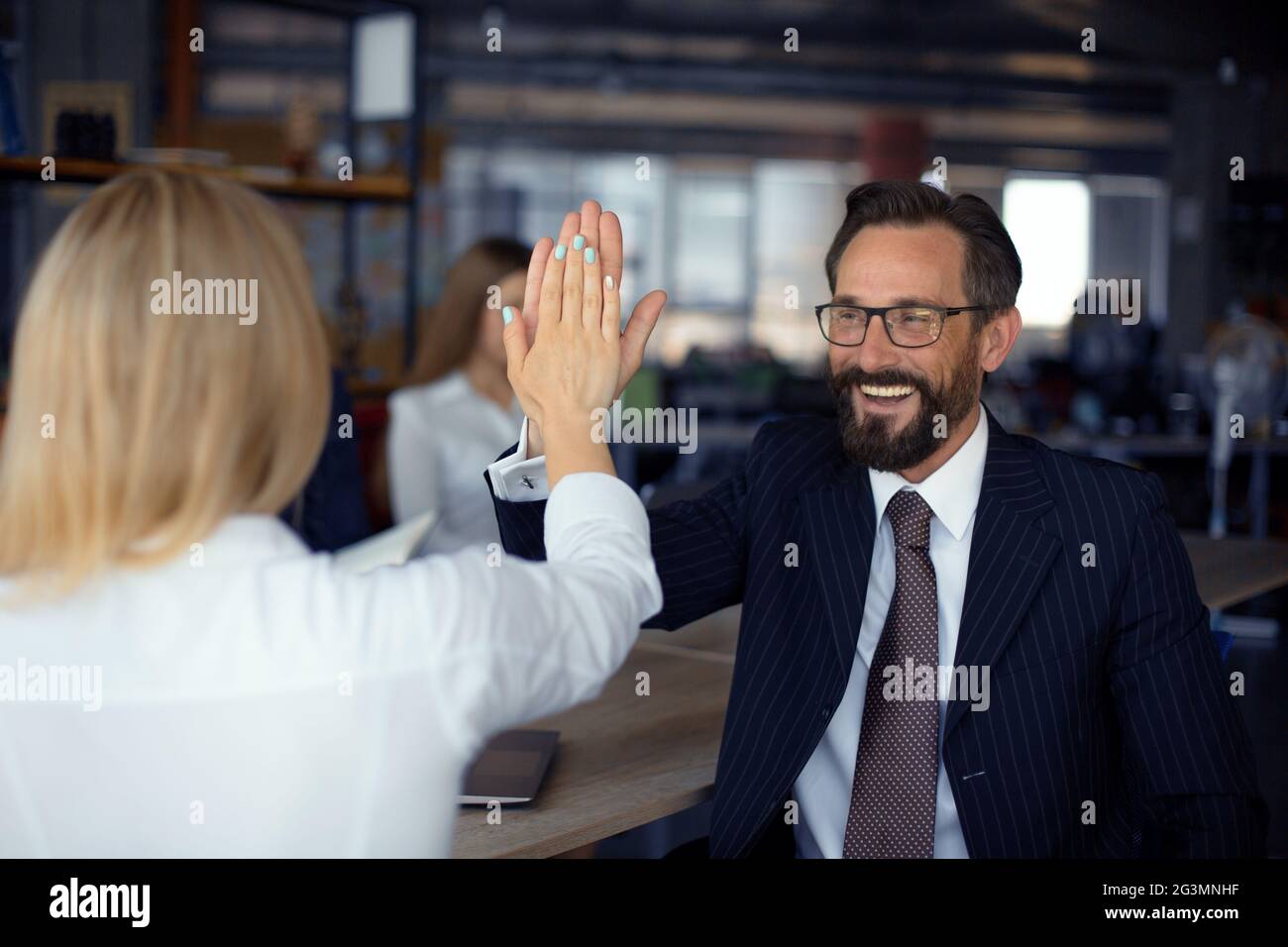 Business people giving five after signing contract Stock Photo - Alamy
