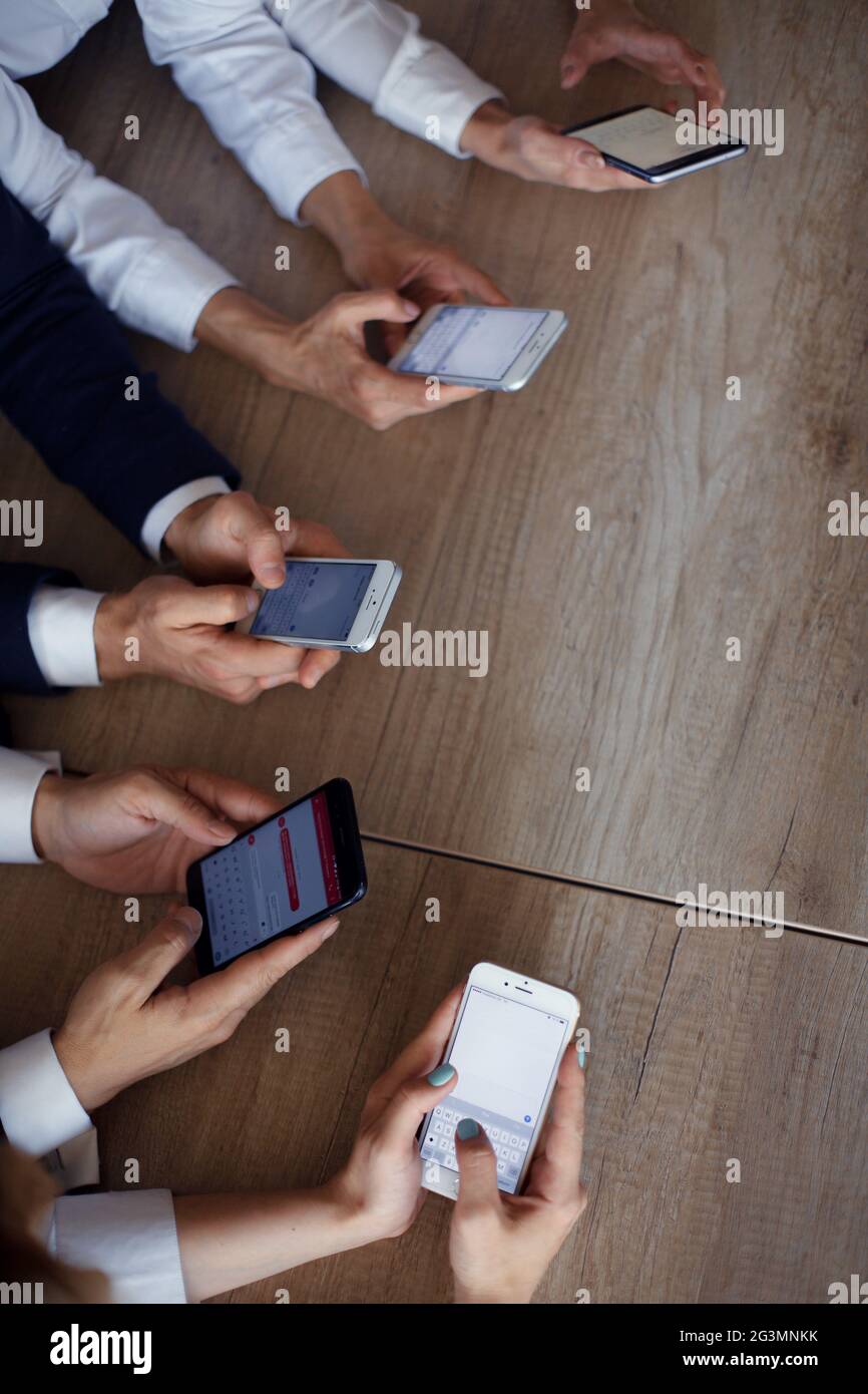 Businesspeople hands using phone Stock Photo - Alamy
