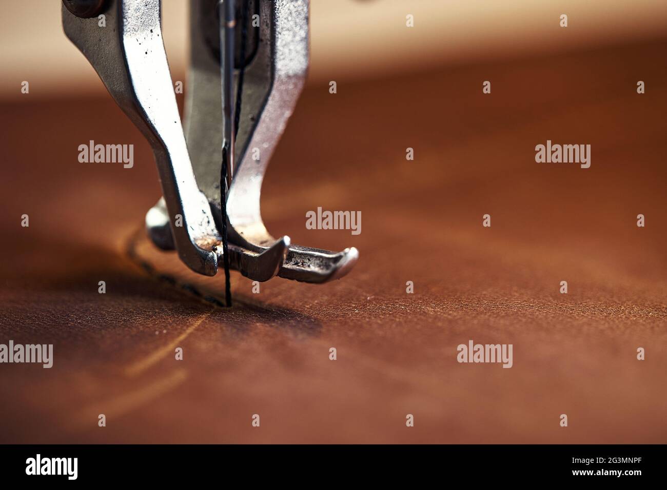 Machine head with a needle close-up, a sewing machine makes a seam on a ...