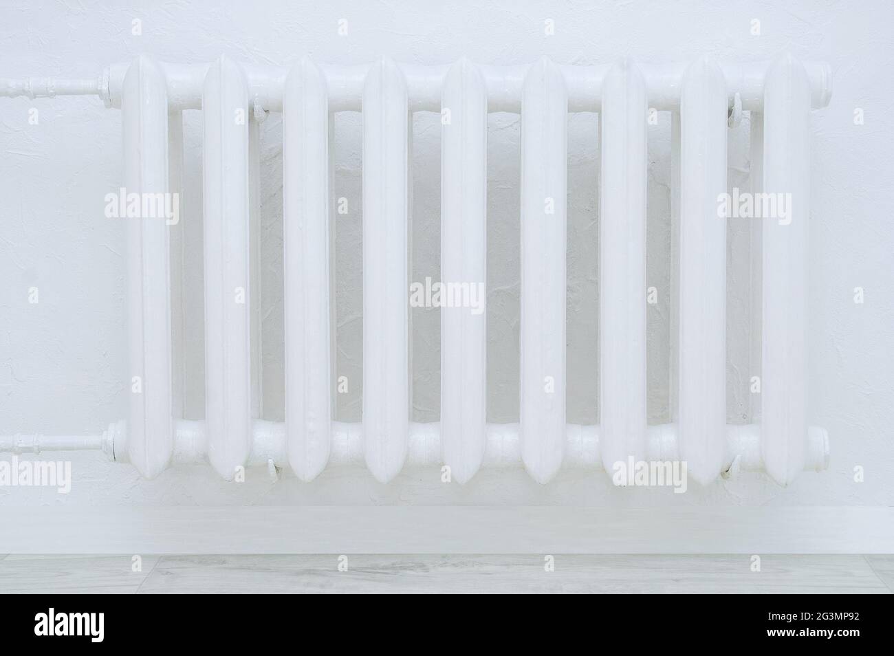White metal retro radiator of water heating on the background of a ...
