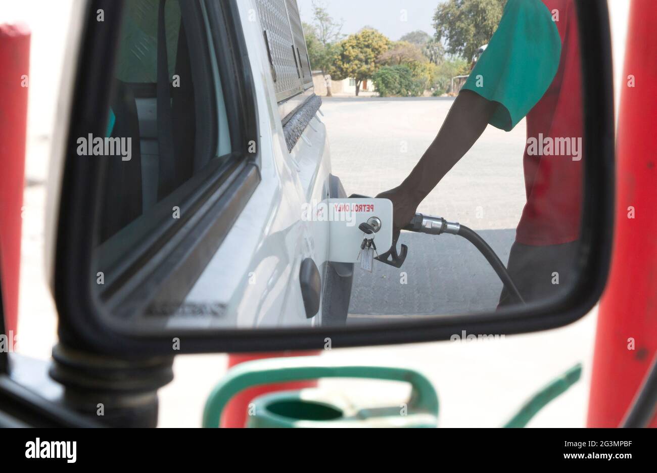Man fueling a car in Africa Stock Photo - Alamy