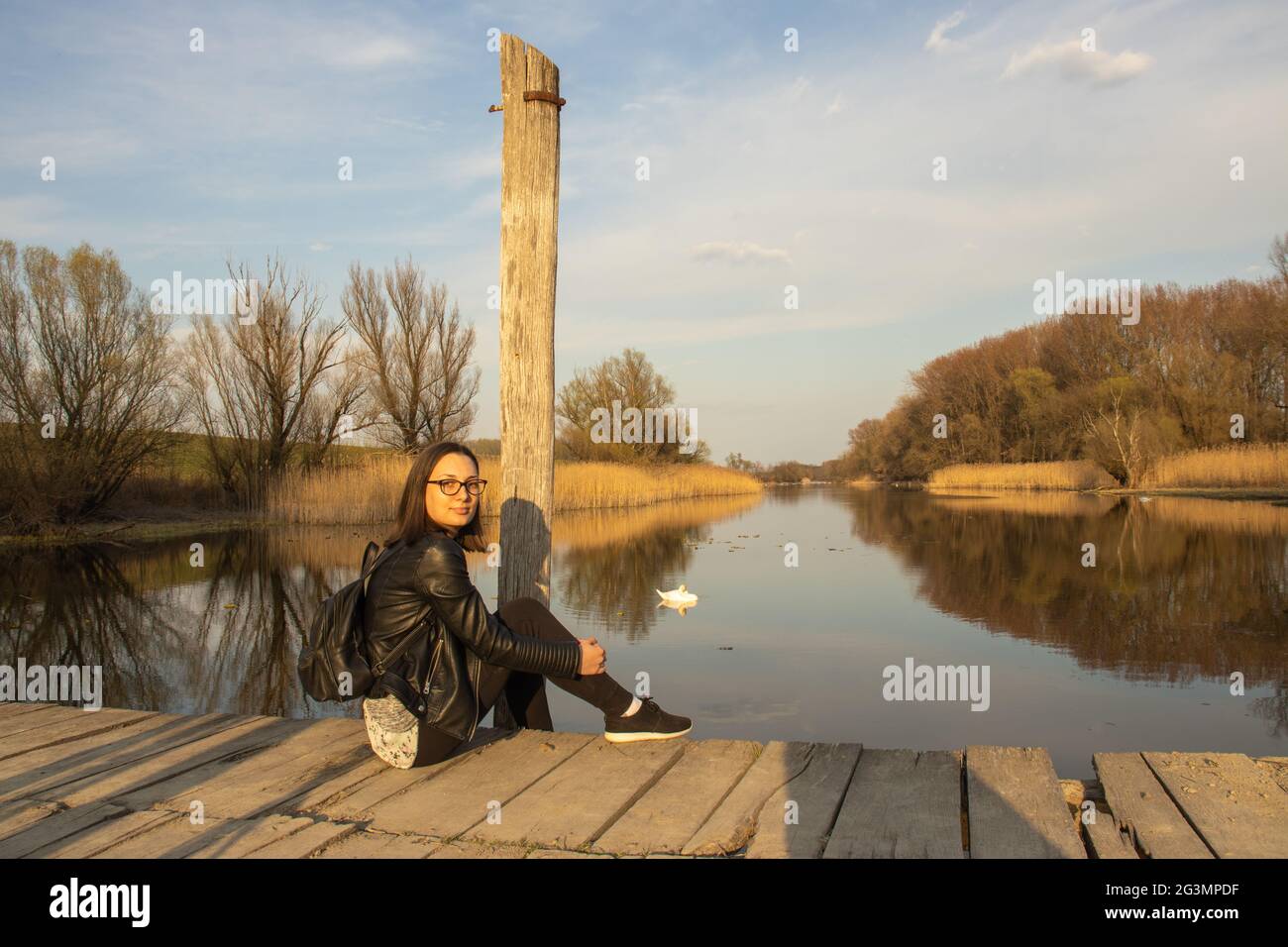 Woman sitting on wood bridge hi-res stock photography and images - Alamy