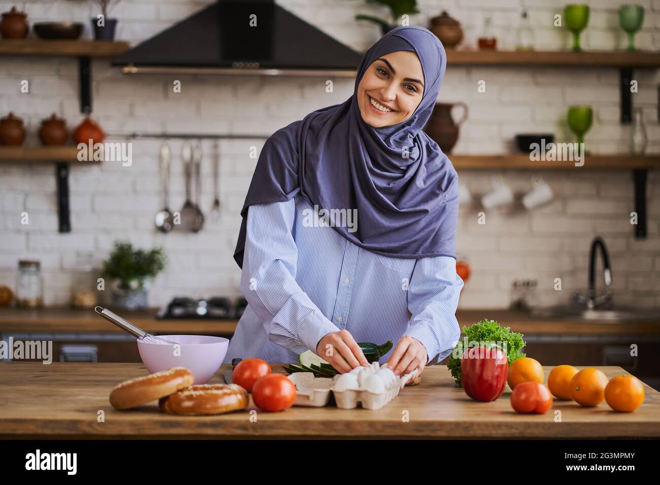 Pretty Muslim woman in hijab preparing ingredients for cooking Stock ...