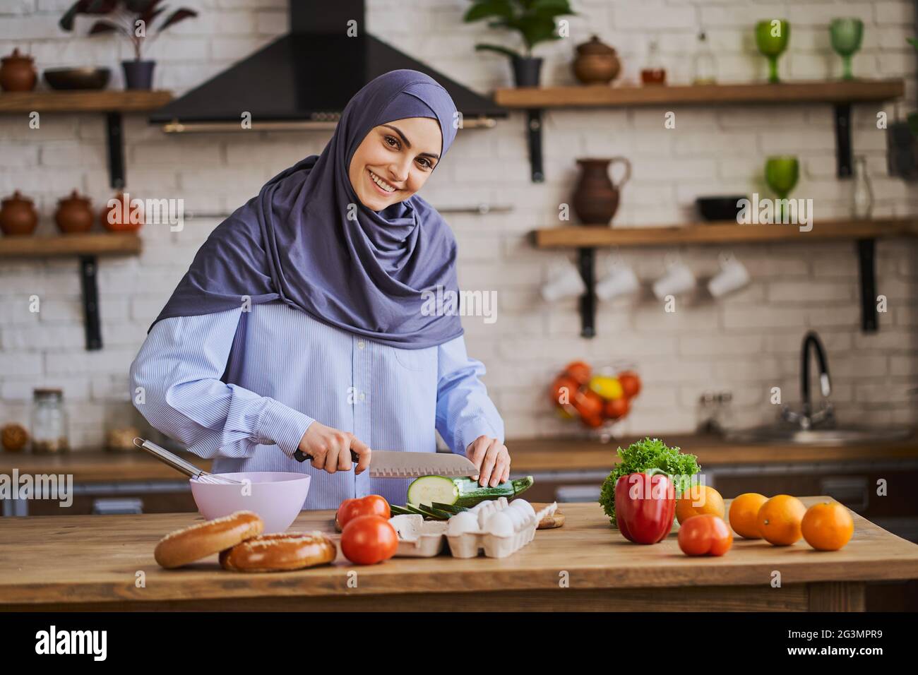 Arabian woman cooking a vegetarian meal with fresh vegetables Stock ...