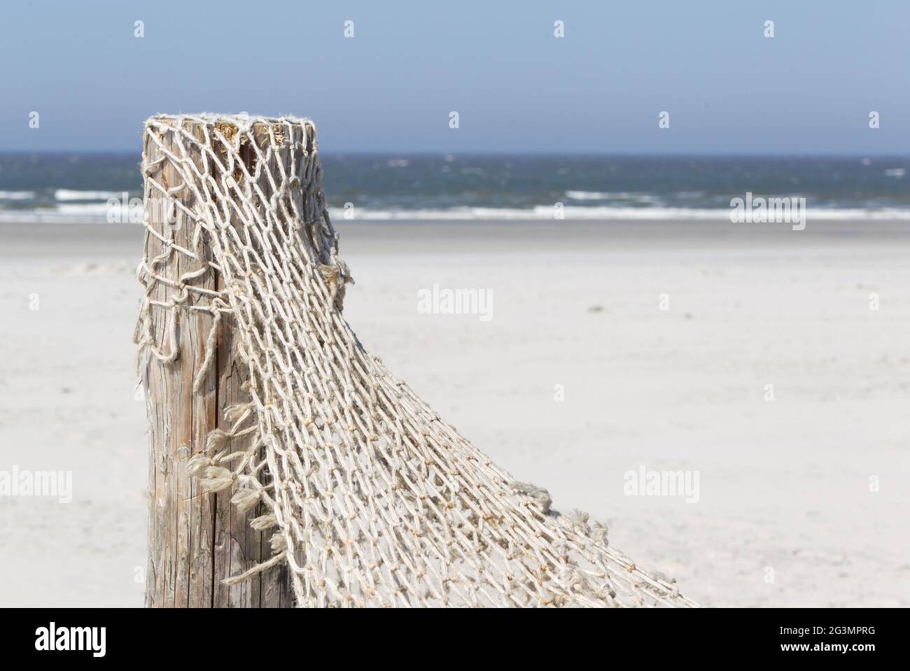 Fishnet on a beach Stock Photo - Alamy