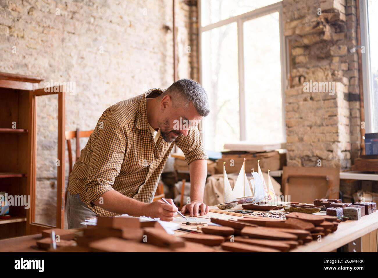 A close up view of a joiner sketching at his workspace Stock Photo - Alamy