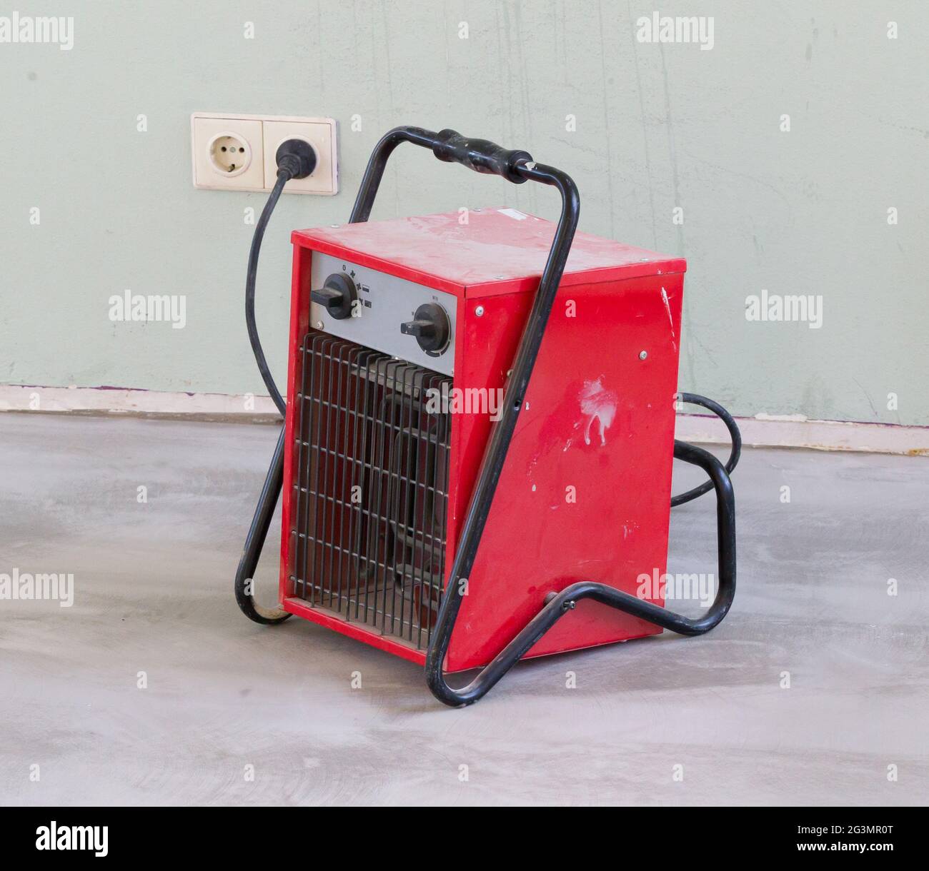 Compact red heater, drying the floor Stock Photo - Alamy