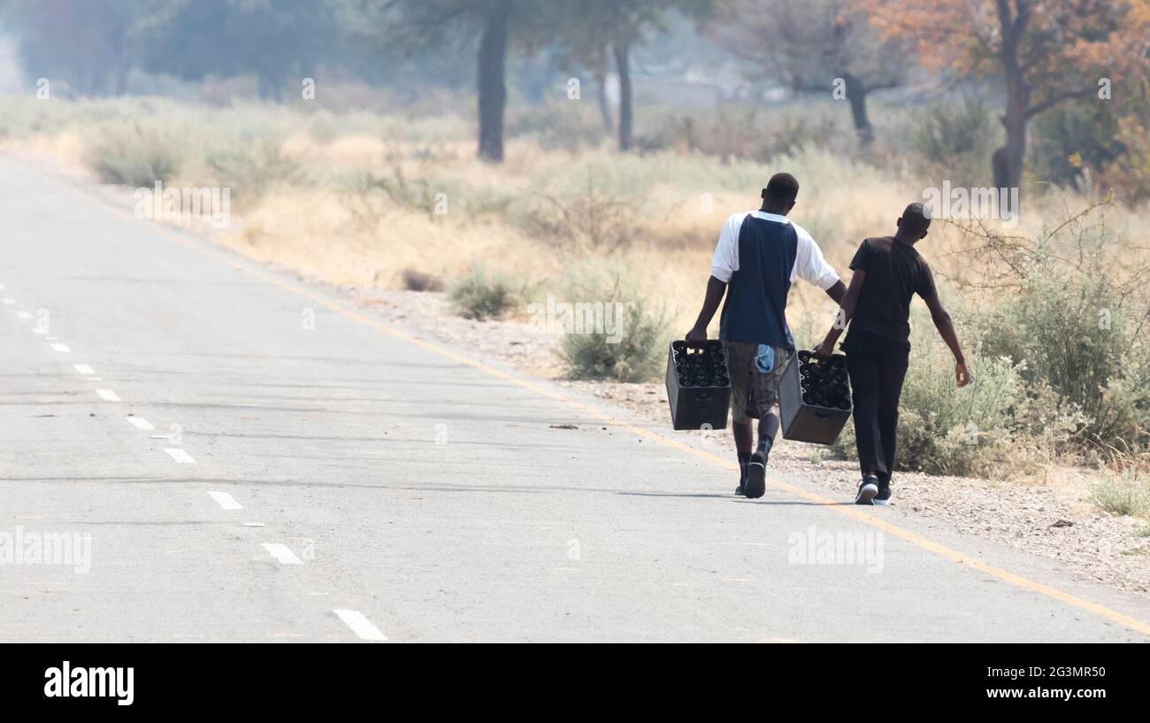 People walking at the side of the road Stock Photo - Alamy