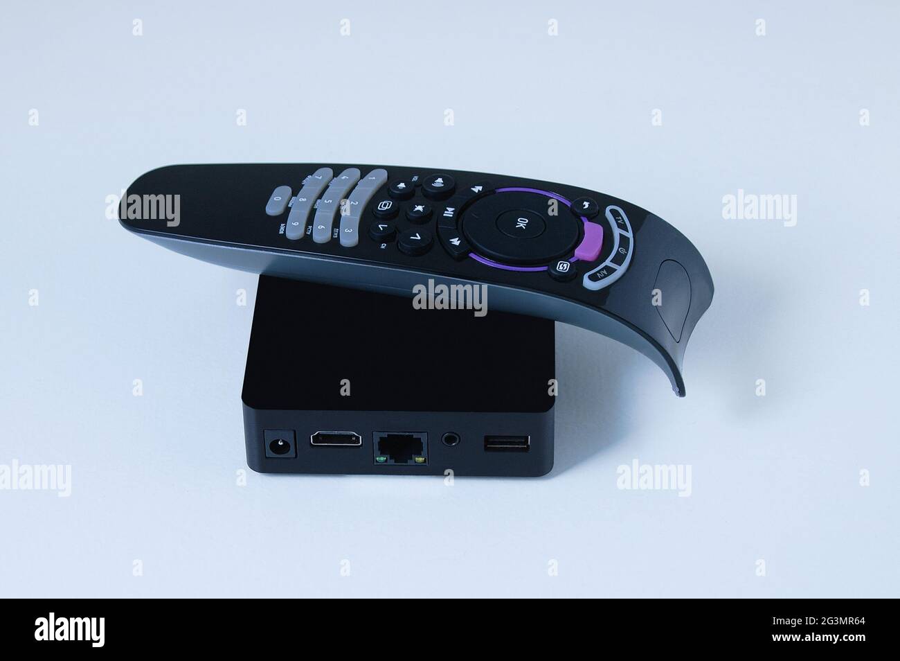 TV box black box with remote control. White background Stock Photo - Alamy