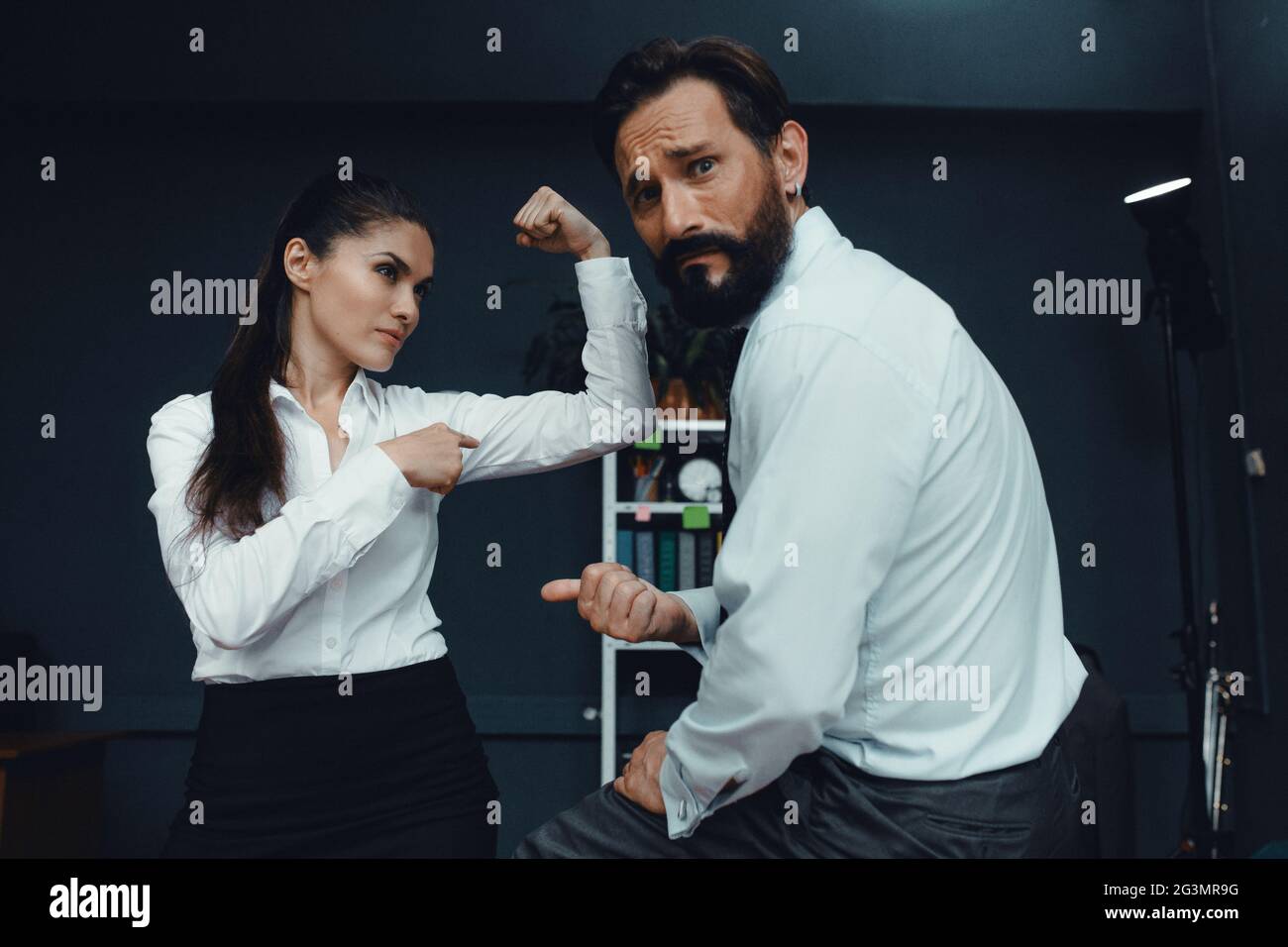 Business people showing muscles in office Stock Photo - Alamy