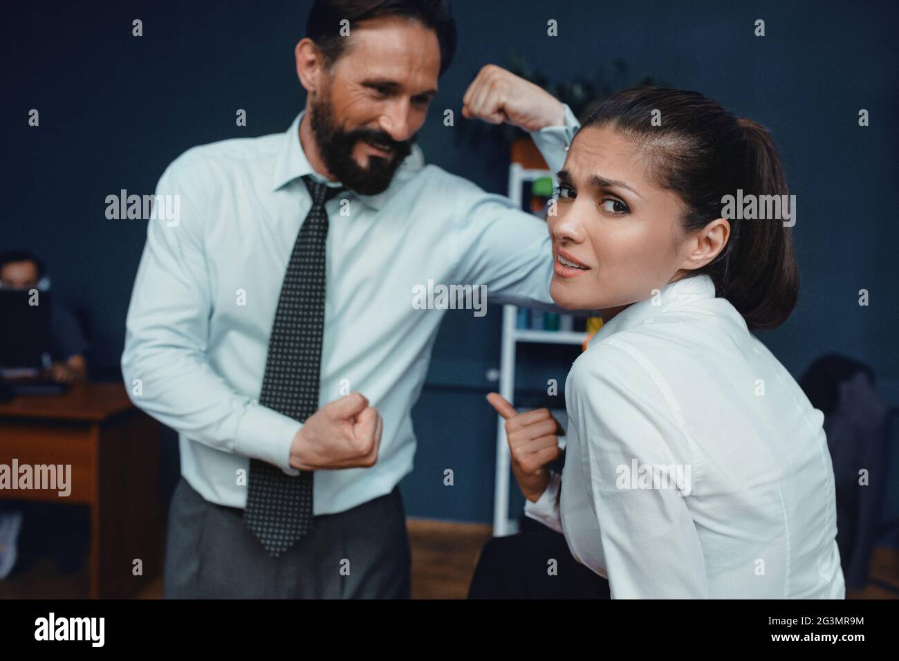 Business people showing muscles in office Stock Photo - Alamy