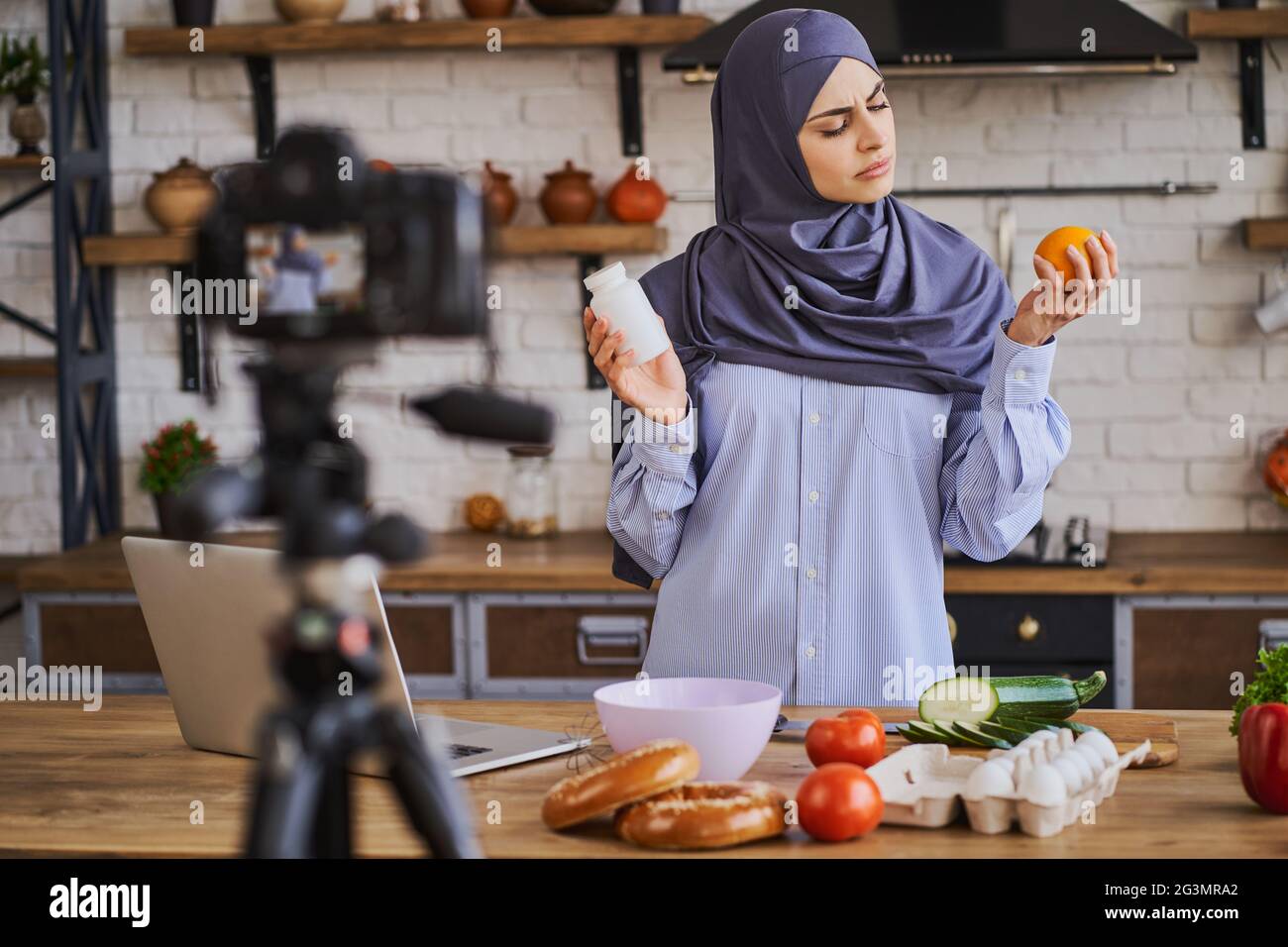 Arabian female food blogger comparing supplements and natural food ...