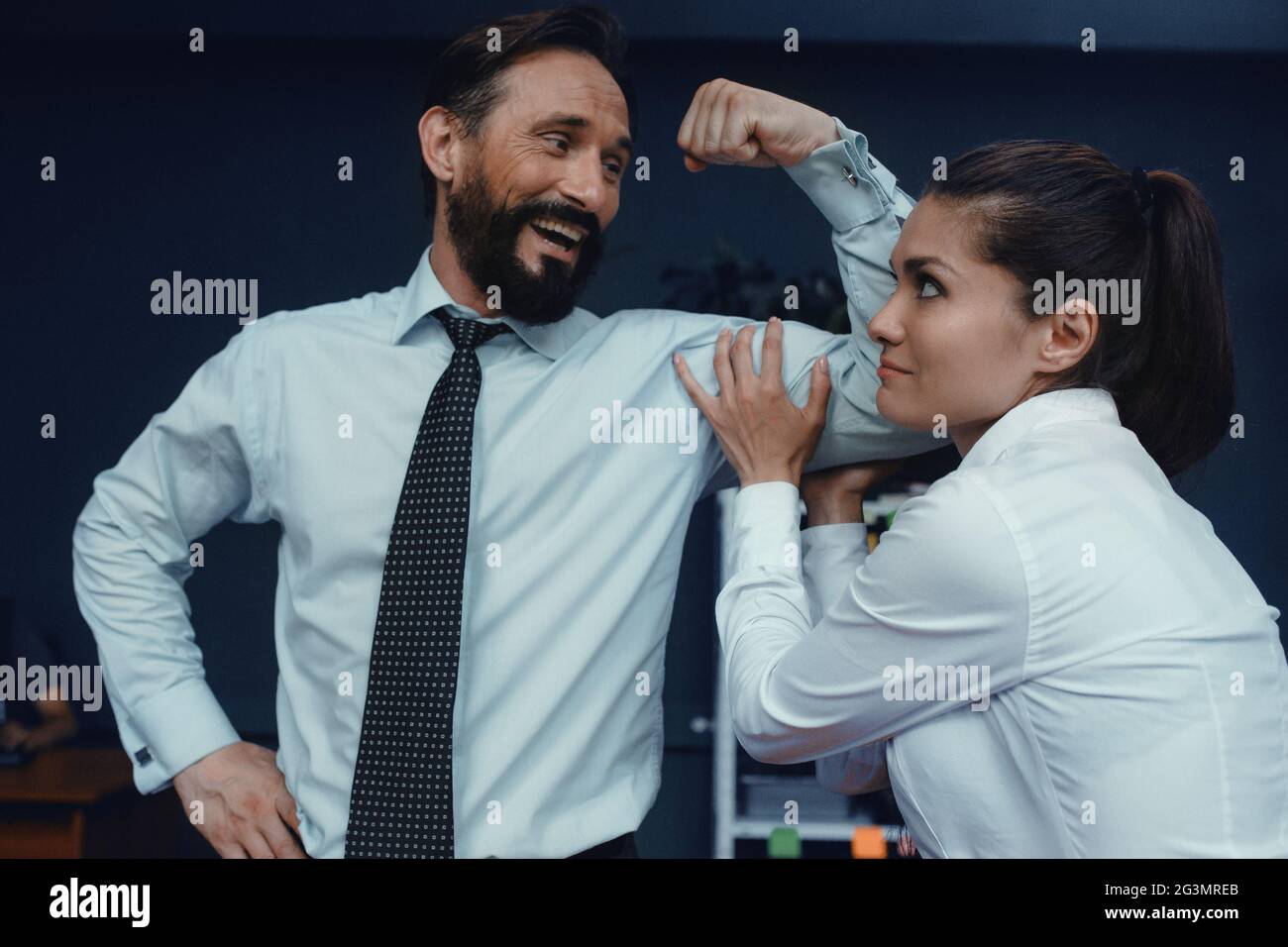 Business people showing muscles in office Stock Photo - Alamy