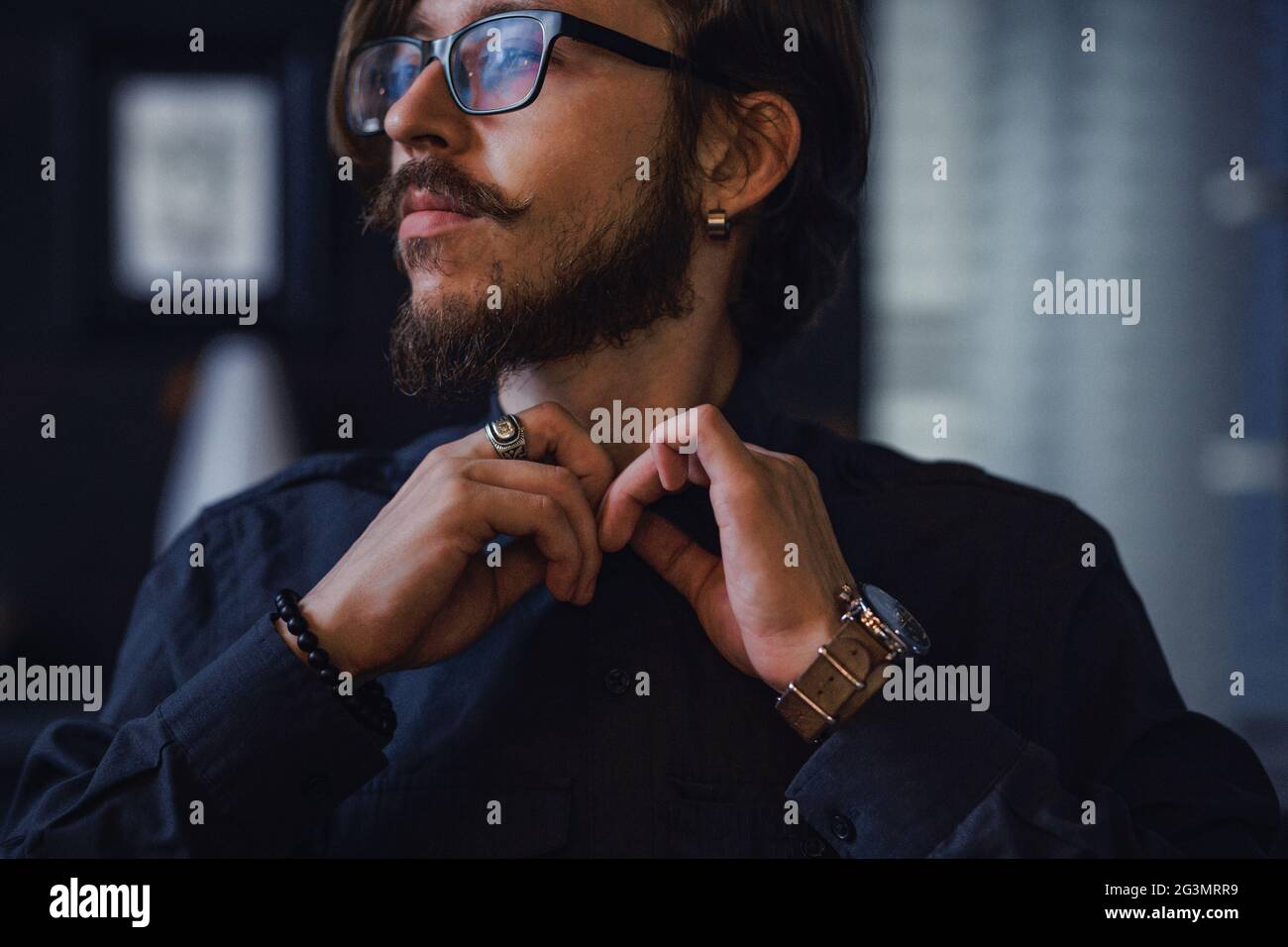 Guy is buttoning his shirt Stock Photo - Alamy