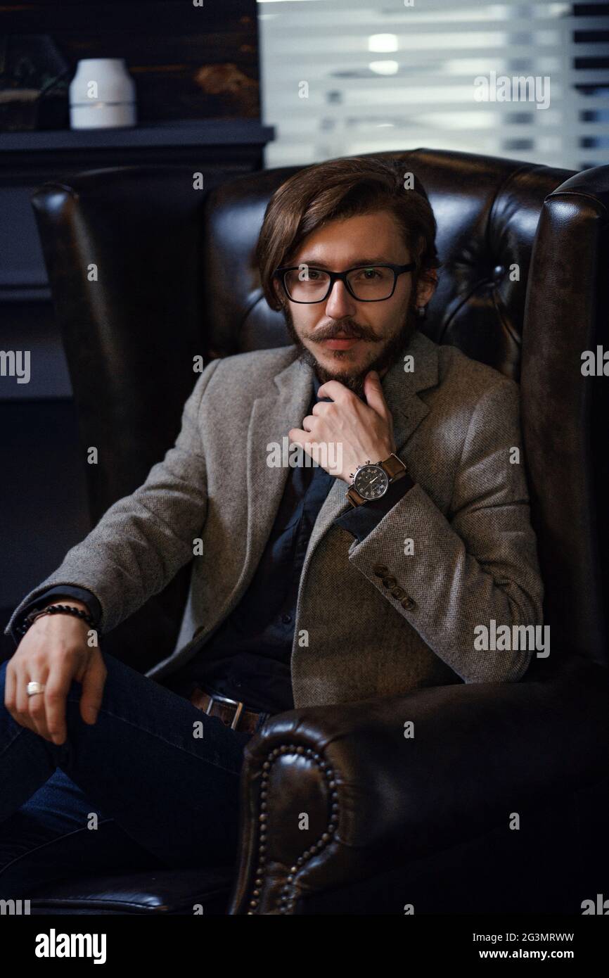 Portrait of a man sitting in a chair Stock Photo - Alamy