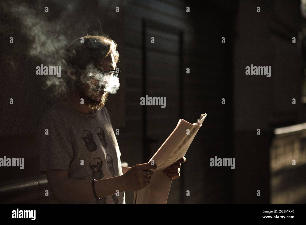 Smoking cigar and reading newspaper hi-res stock photography and images ...