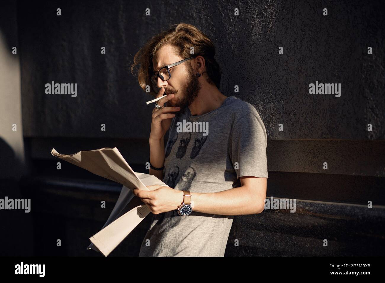 Man reading a newspaper on the street Stock Photo - Alamy