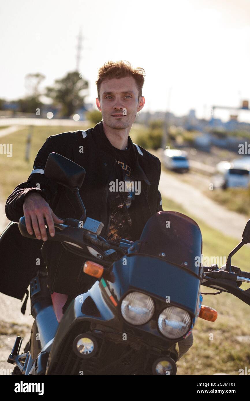 Handsome motorcyclist sitting on the bike Stock Photo - Alamy