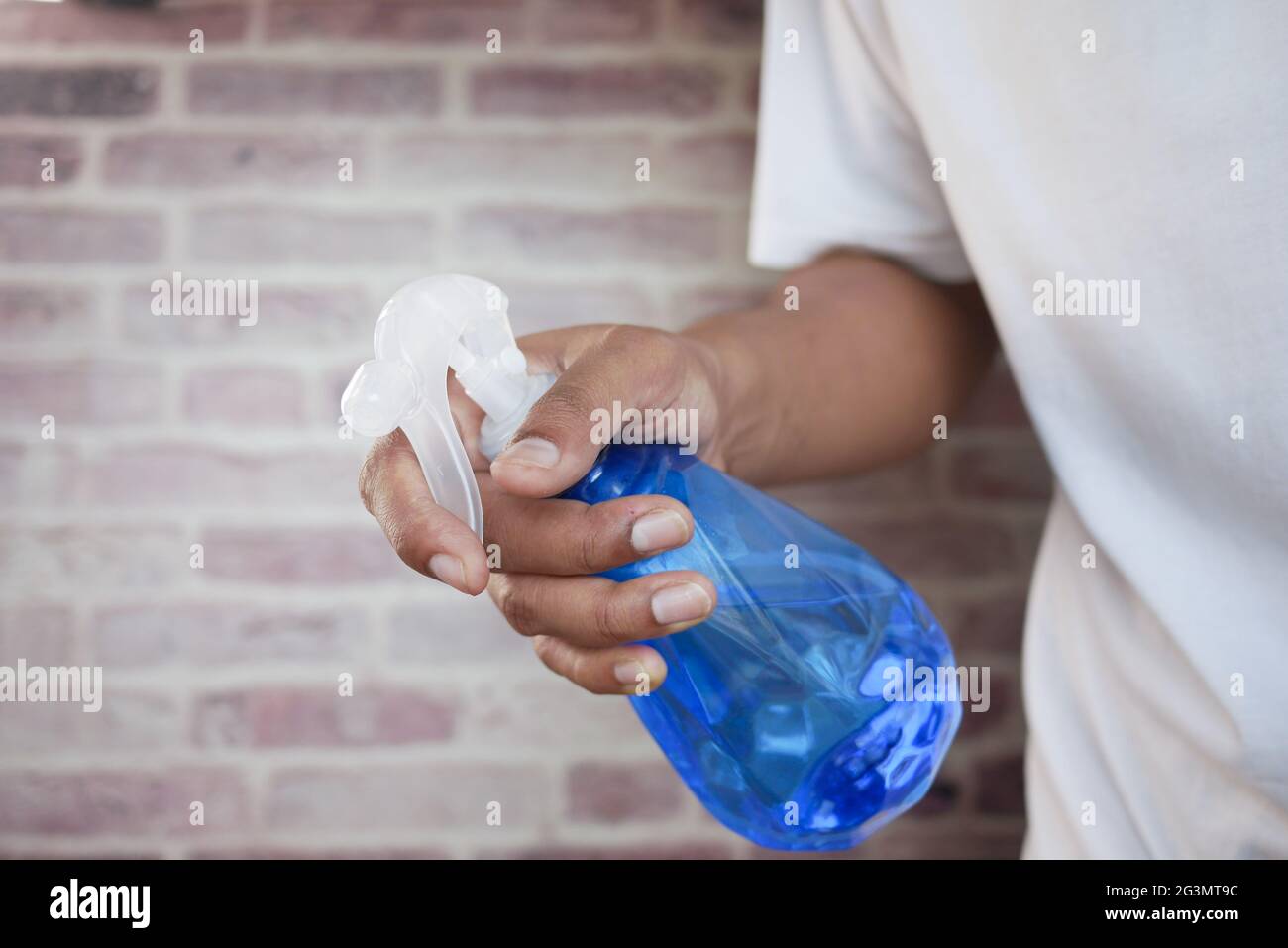 using disinfectant spray to clean table surface Stock Photo - Alamy