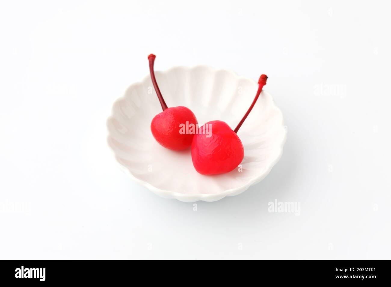 canned red cherries in syrup on plate isolated on white background ...