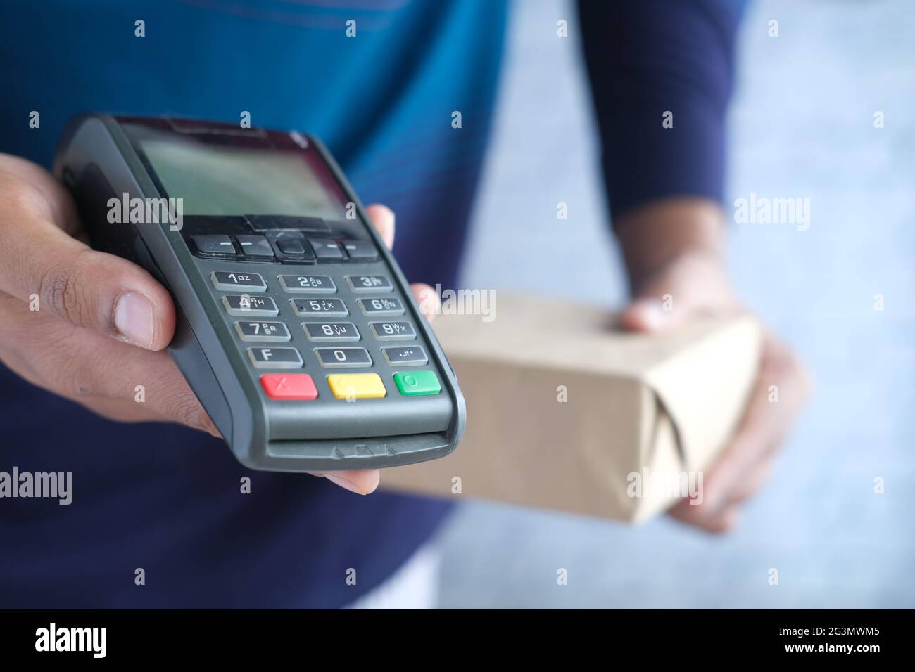 hand holding pos machine close up Stock Photo - Alamy