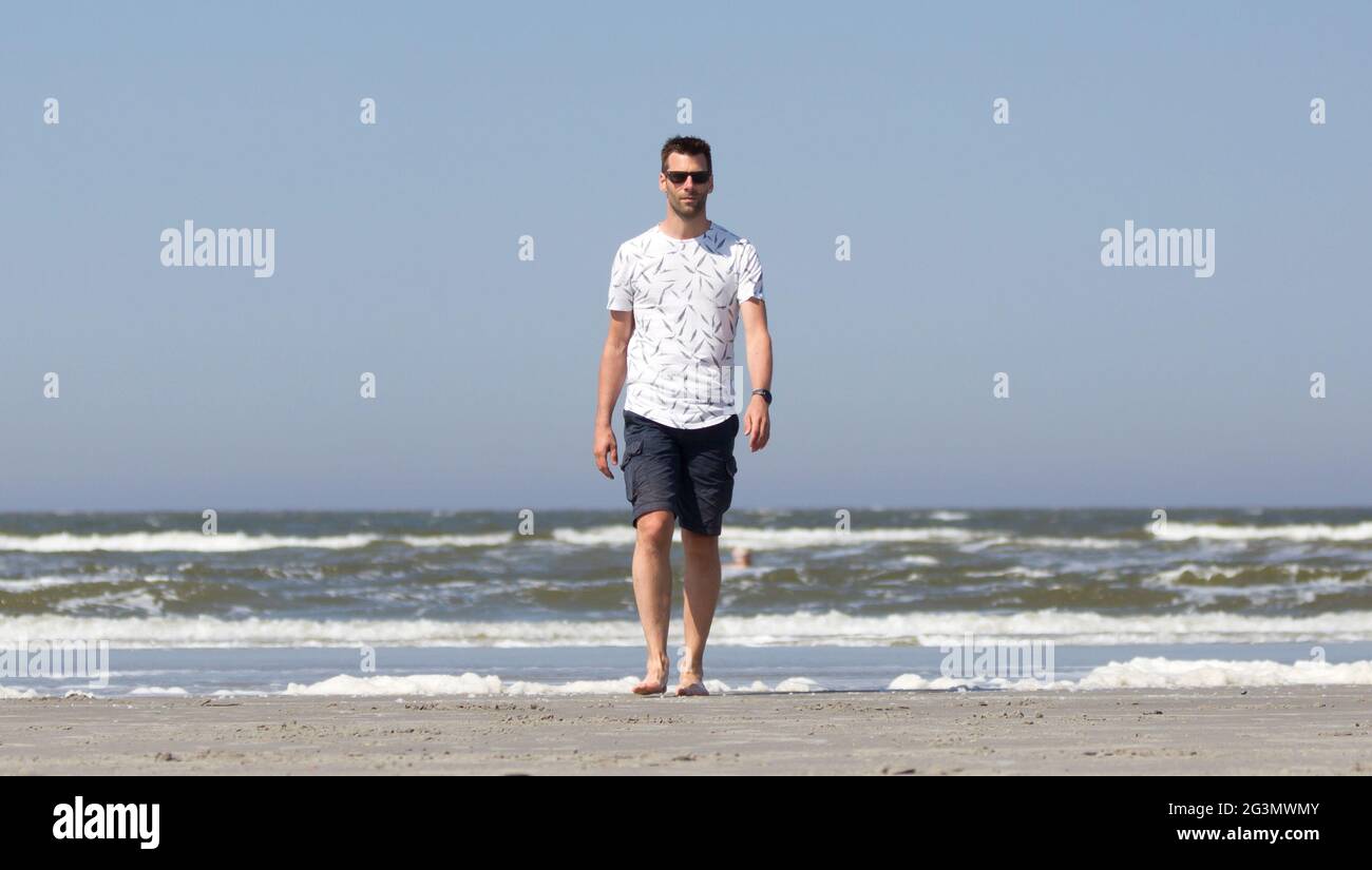 Dutch man on a beach Stock Photo - Alamy