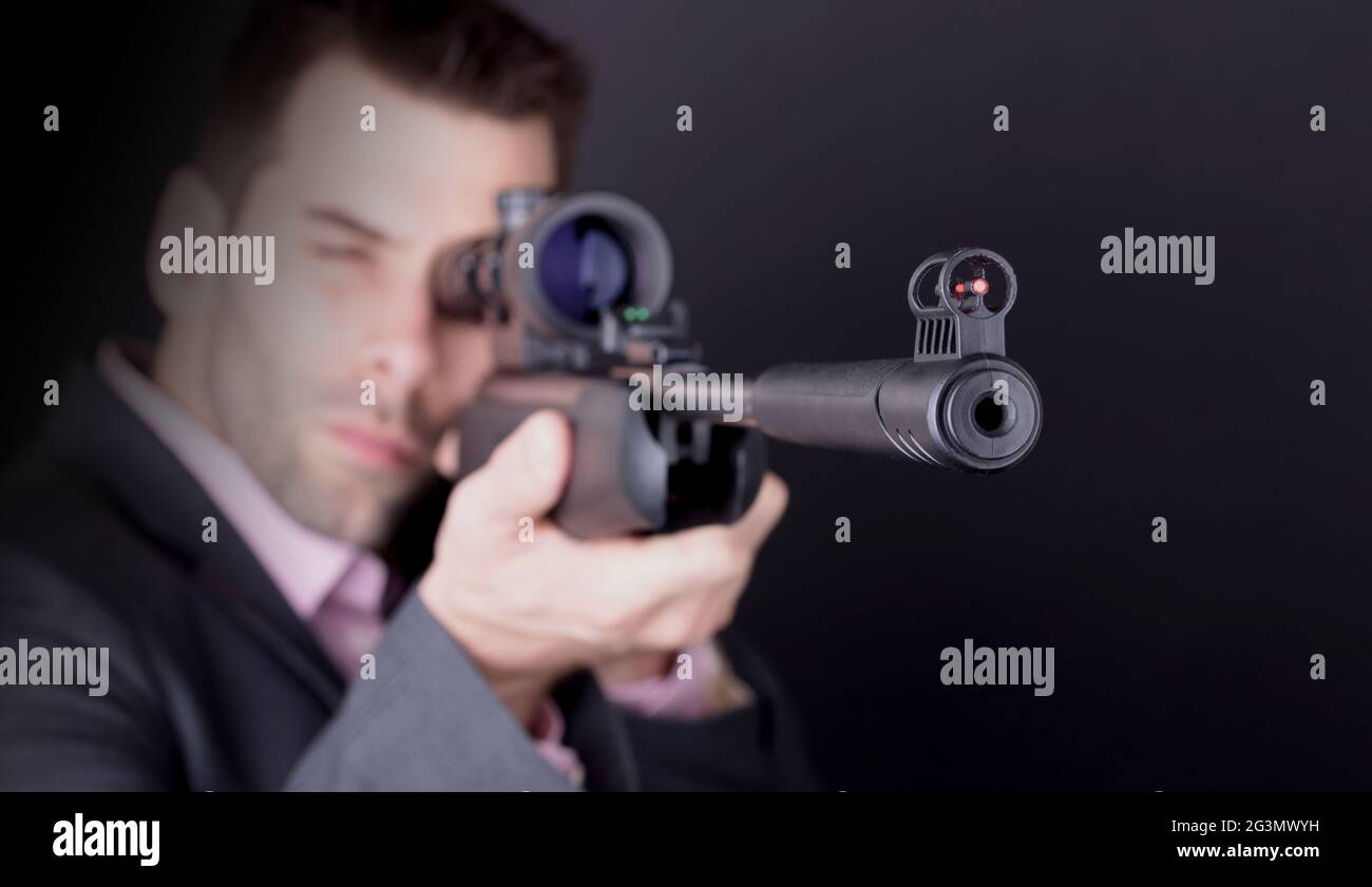 Man in suit with rifle and scope Stock Photo - Alamy