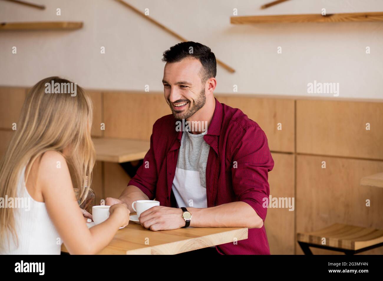 Cute couple having coffee together in cafe Stock Photo - Alamy