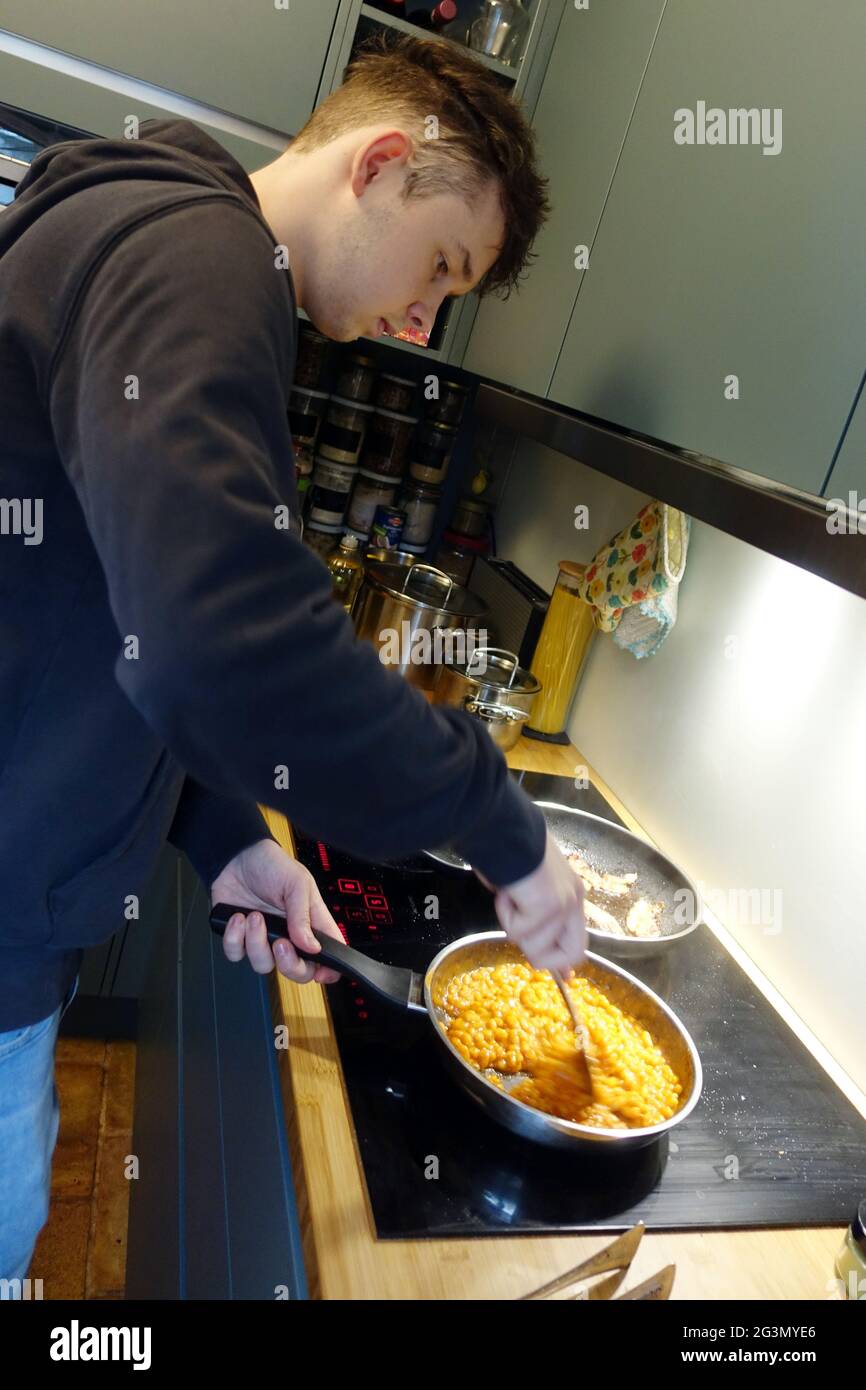 Young man eating beans model hi-res stock photography and images - Alamy