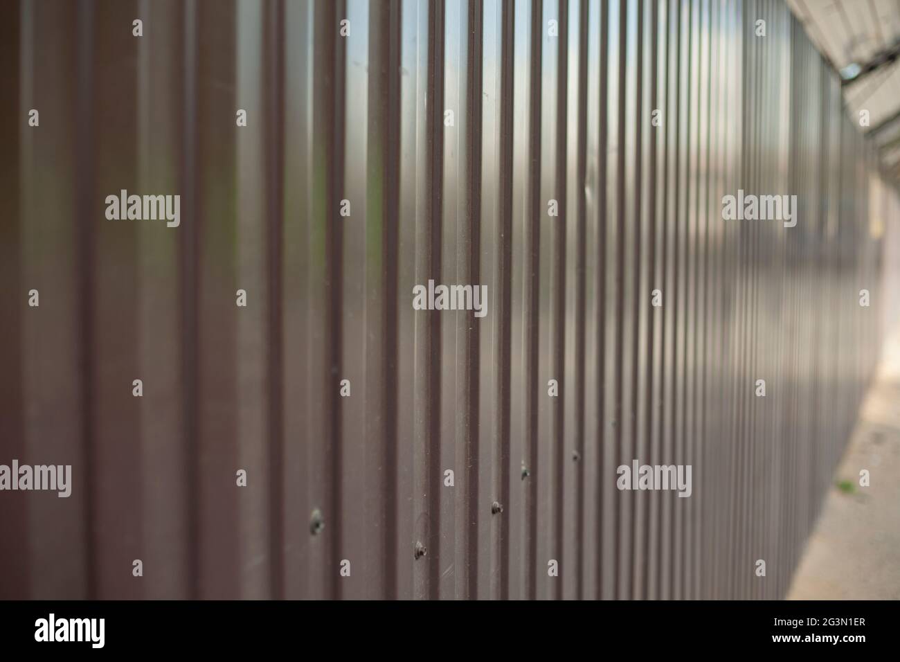 The metal fence is brown. Solid construction site fencing. High ...