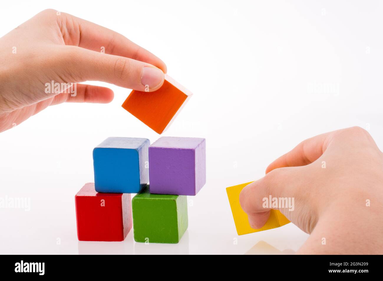 Hand playing with cubes Stock Photo - Alamy