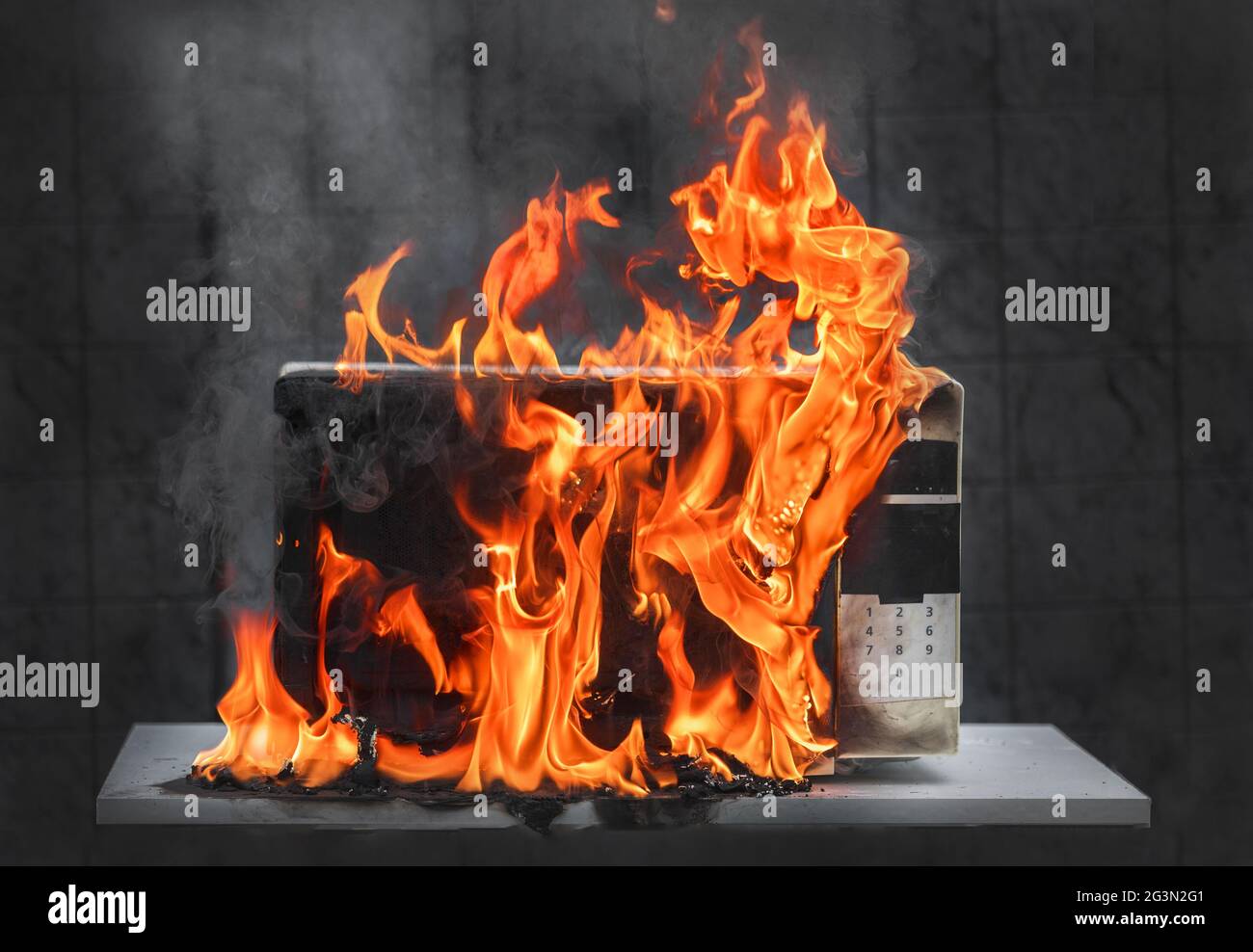 Microwave oven white, in fire front view, electrical appliances caught ...