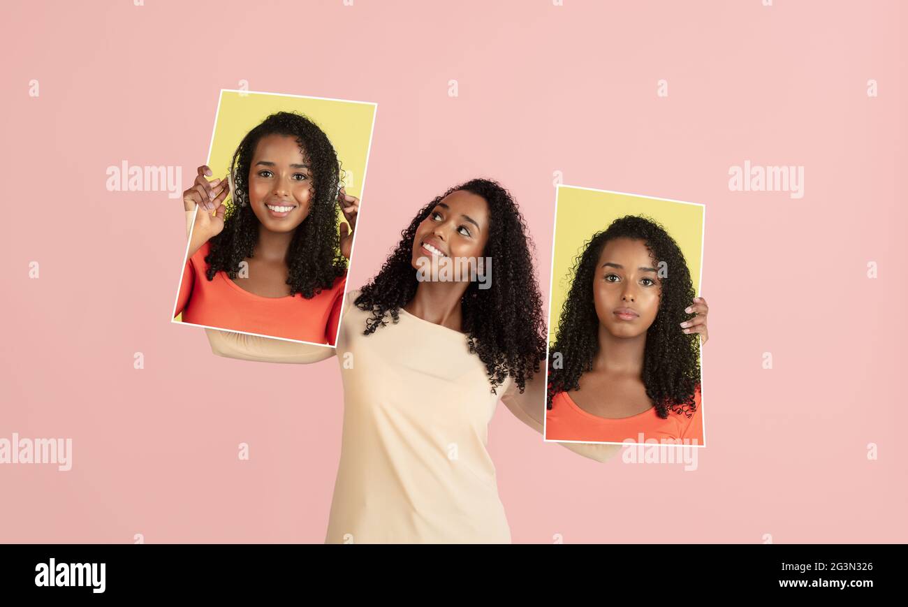 Young attractive girl holding her portraits, pictures isolated on light ...