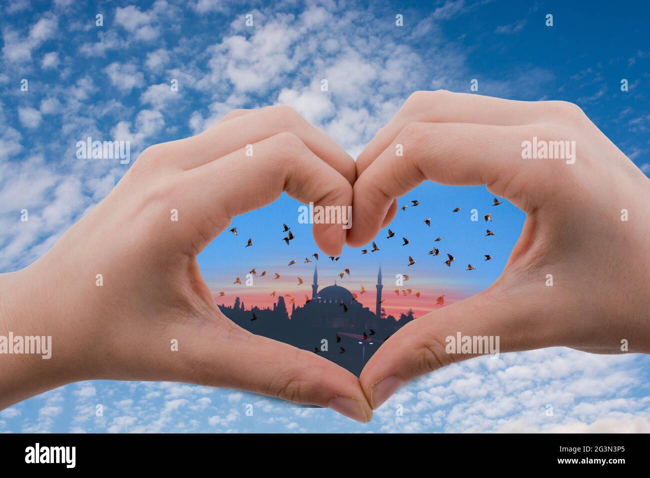 Mosque view seen behind a heart shaped hand Stock Photo - Alamy