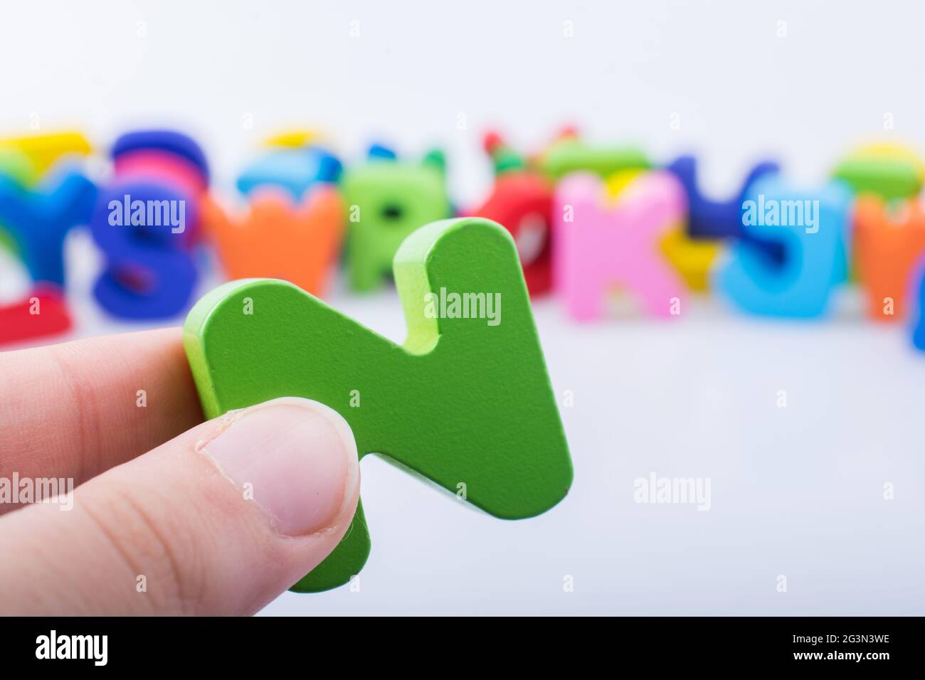 Hand holding Letter cube N of Alphabet Stock Photo - Alamy