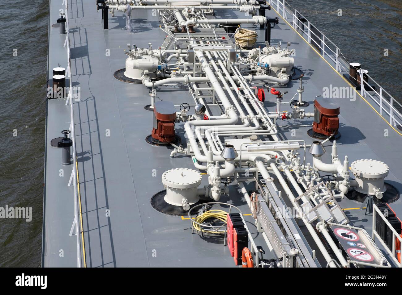 Inland vessel seen from above with pipelines on the deck for industrial ... Inland vessel seen from above with pipelines on the deck for industrial ...