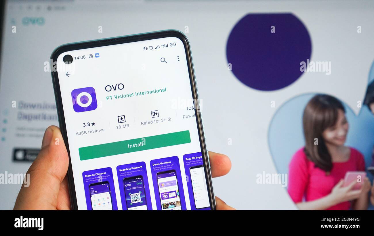 Ovo app display on smartphone, man's hand holding mobile phone : Indonesia, Pekanbaru - June 11 ...