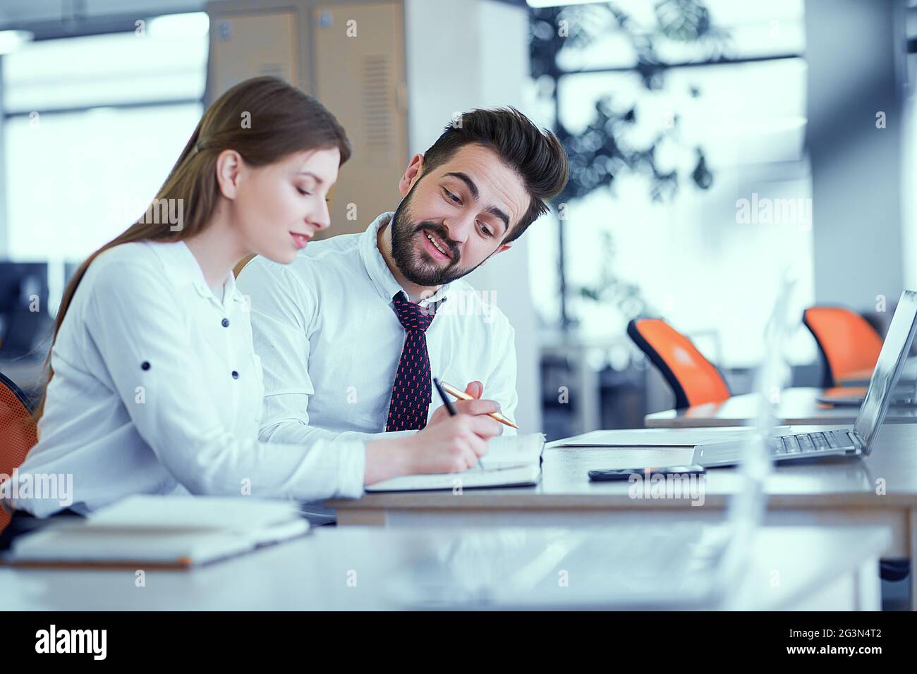 Colleagues sitting desk talking hi-res stock photography and images - Alamy