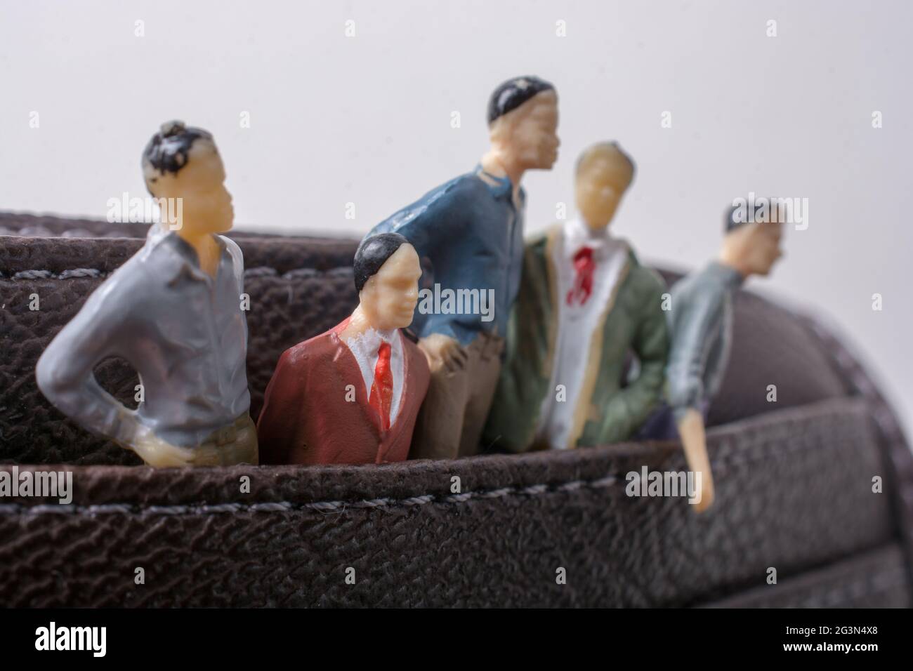 Tiny figurine of men model in pockets Stock Photo - Alamy