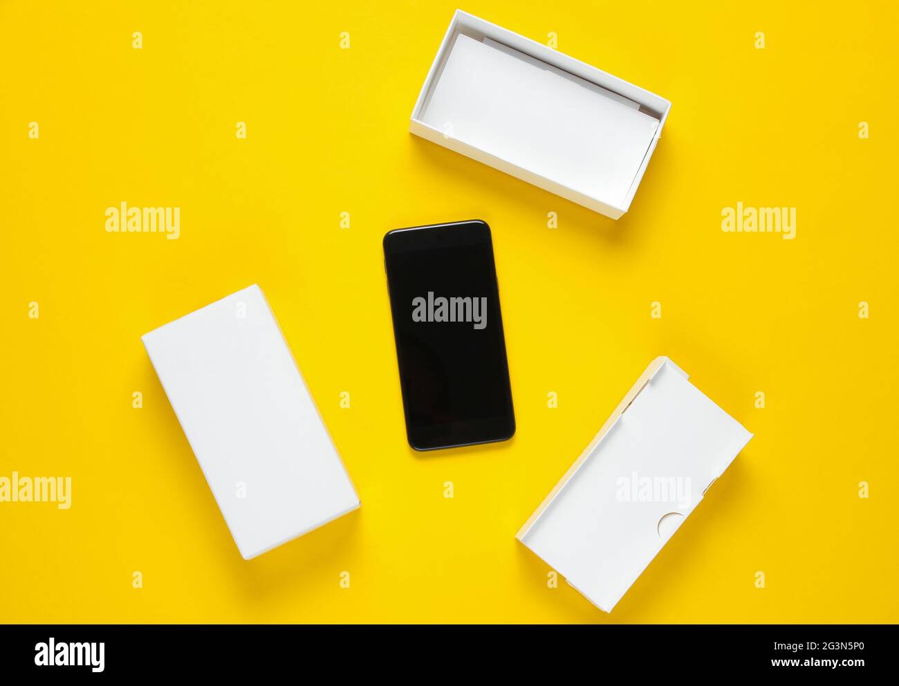 New smartphone with box on yellow background. Minimalism concept ...