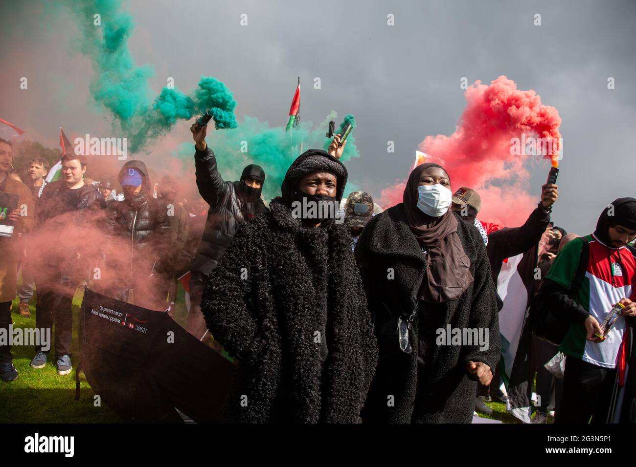 Two women at the Free Palestine Protest with smoke flares in the ...