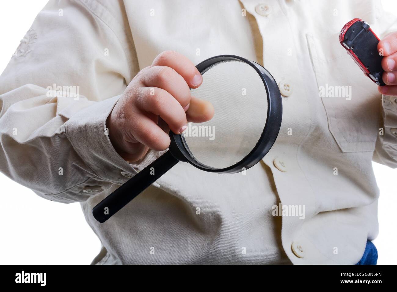 Baby holding a magnifying glass in hand on a white background Stock ...