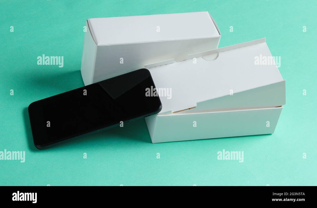 New smartphone with box on blue background. Minimalism concept ...