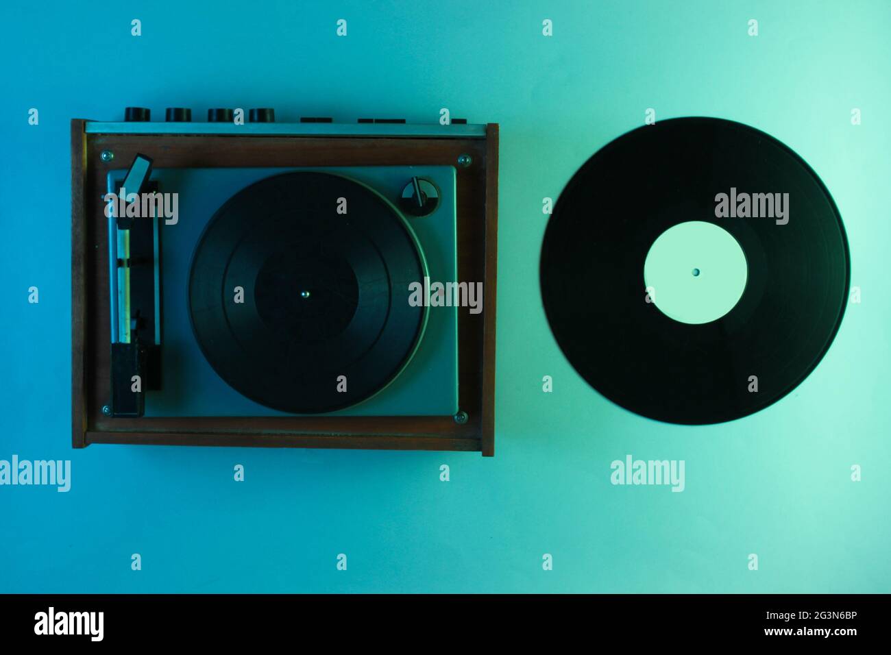 Retro vinyl record player with vinyl plates. Neon light, top view Stock ...