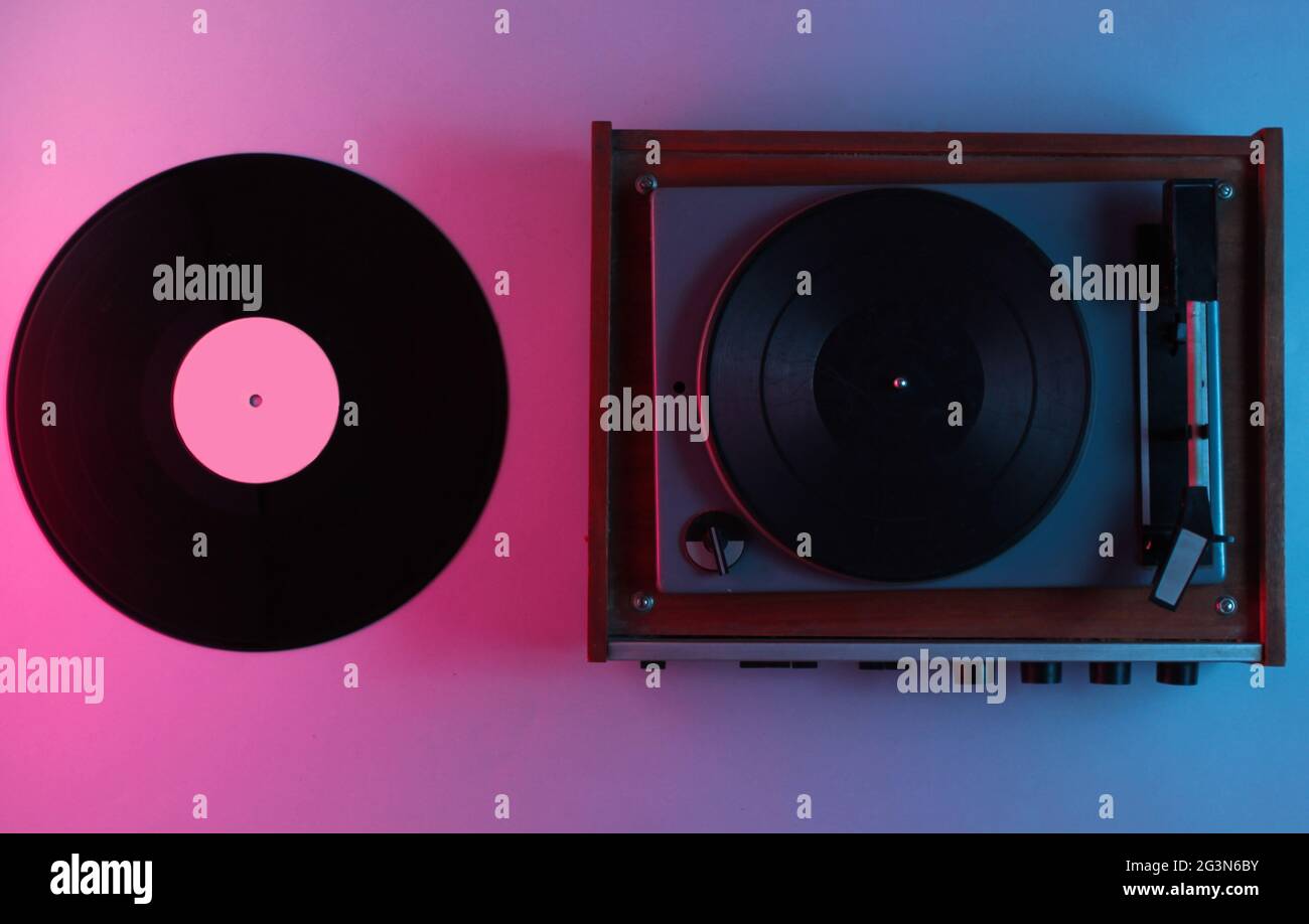 Retro vinyl record player with vinyl plates. Neon light, top view Stock ...