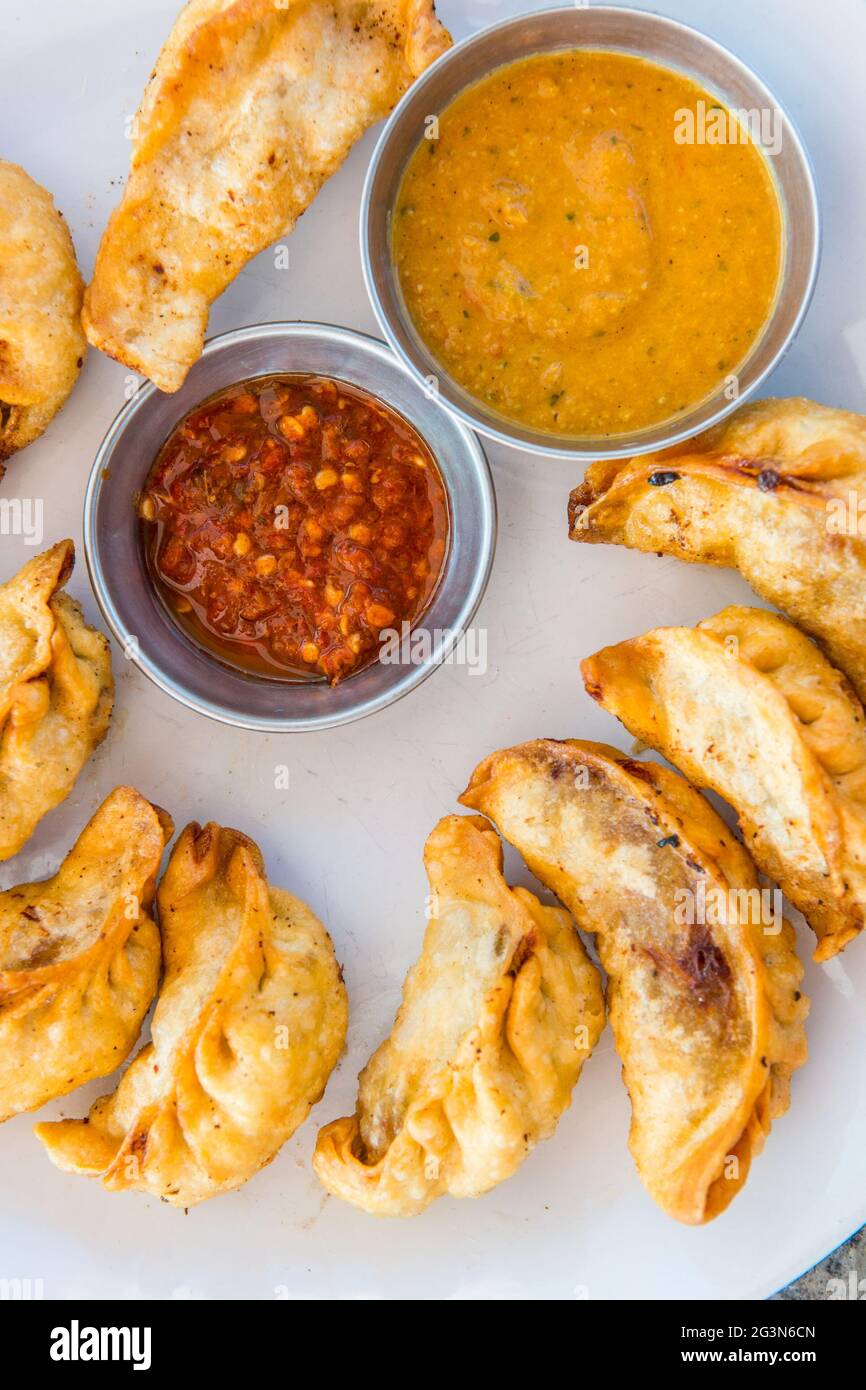 Plate of traditional momos served with tasty dipping Stock Photo - Alamy